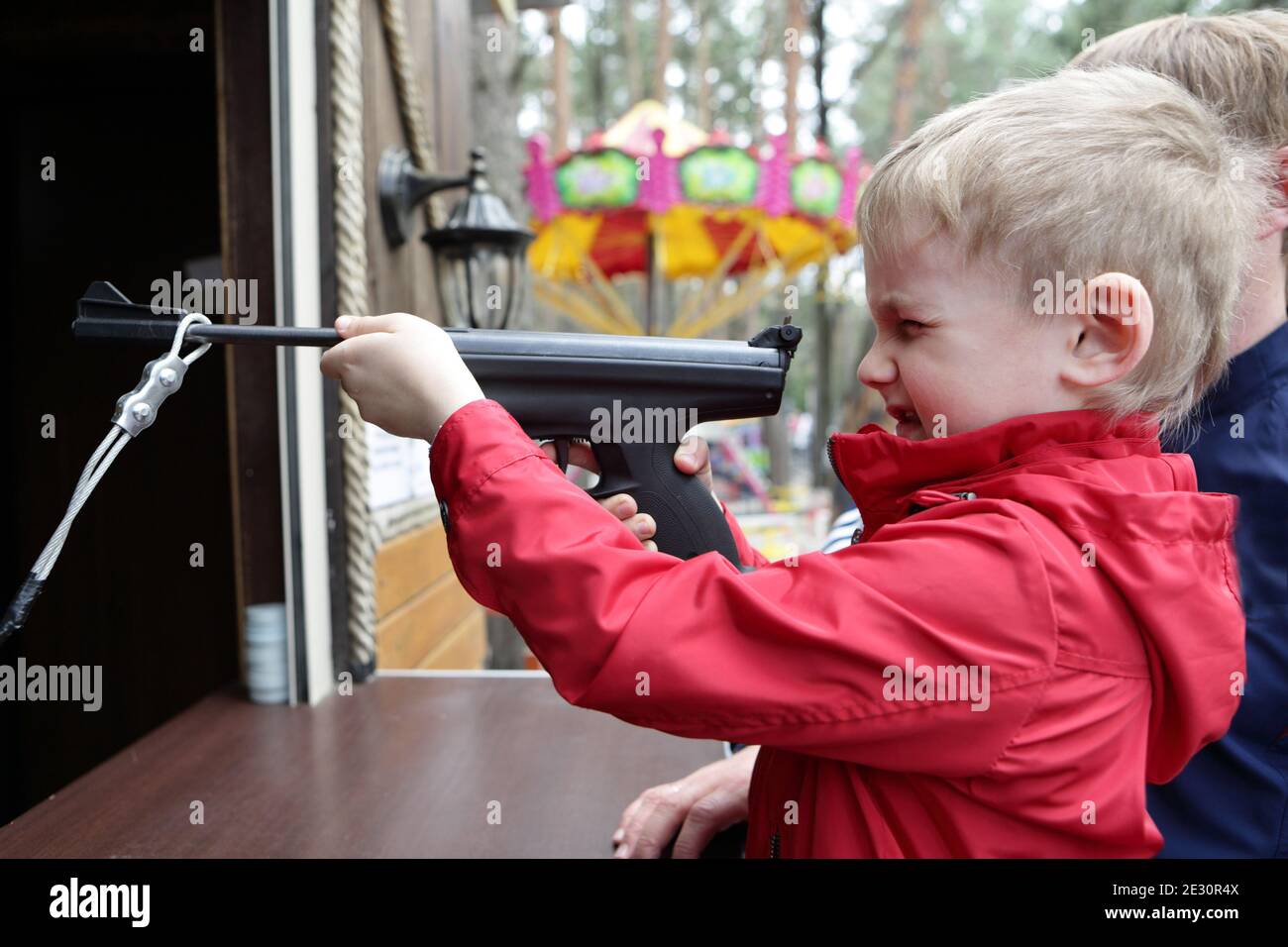 Boy shooting air pistol at the rifle range Stock Photo - Alamy