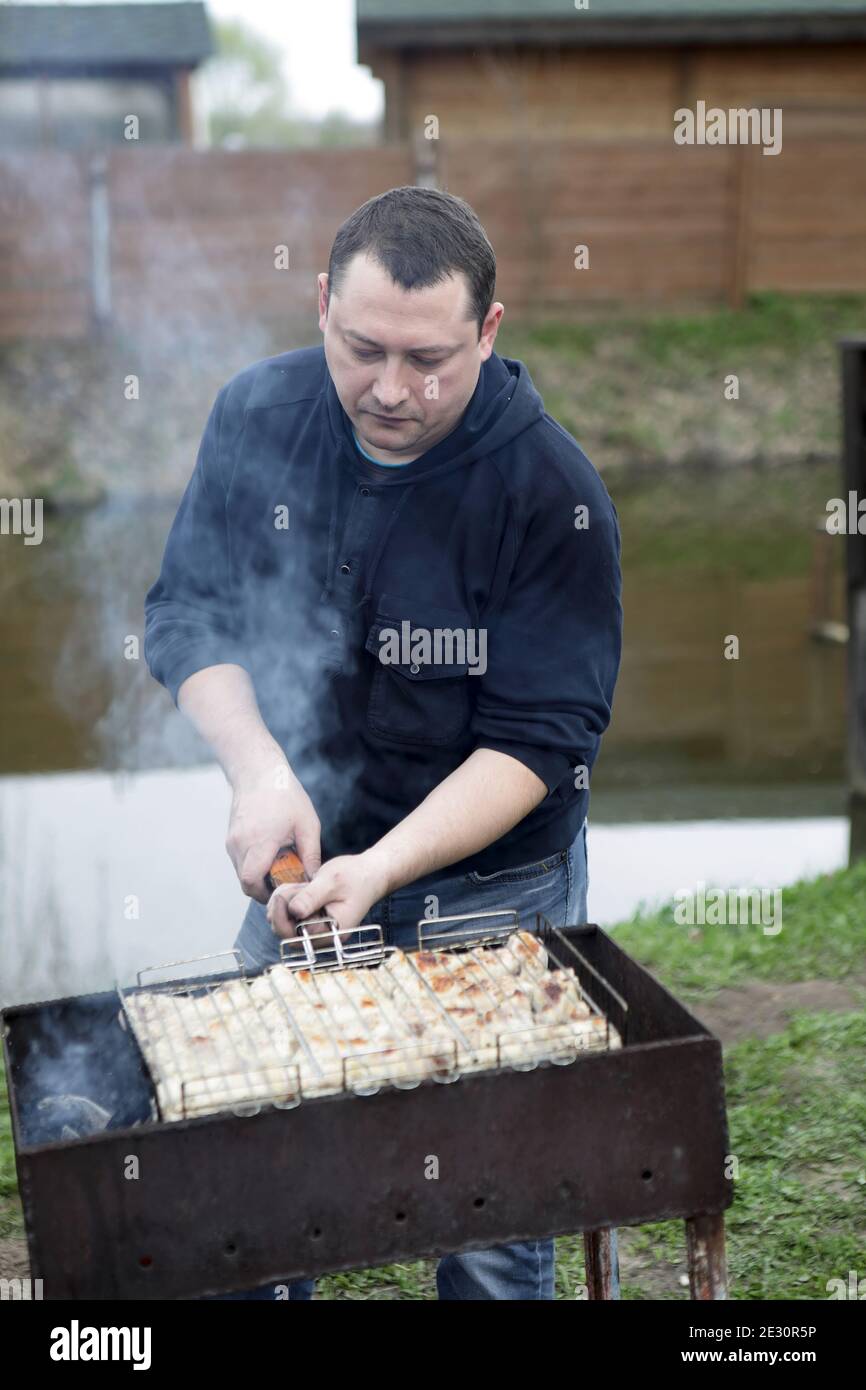 Chicken male adult barbecue cooking hi-res stock photography and images ...