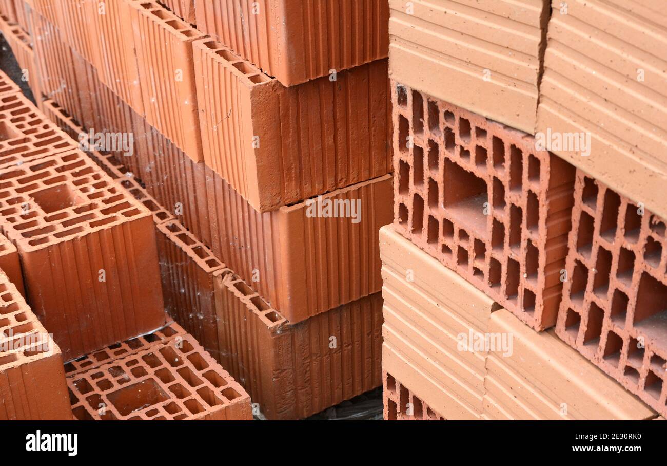 Wall blocks made from red porous ceramics with rectangular holes on a ...