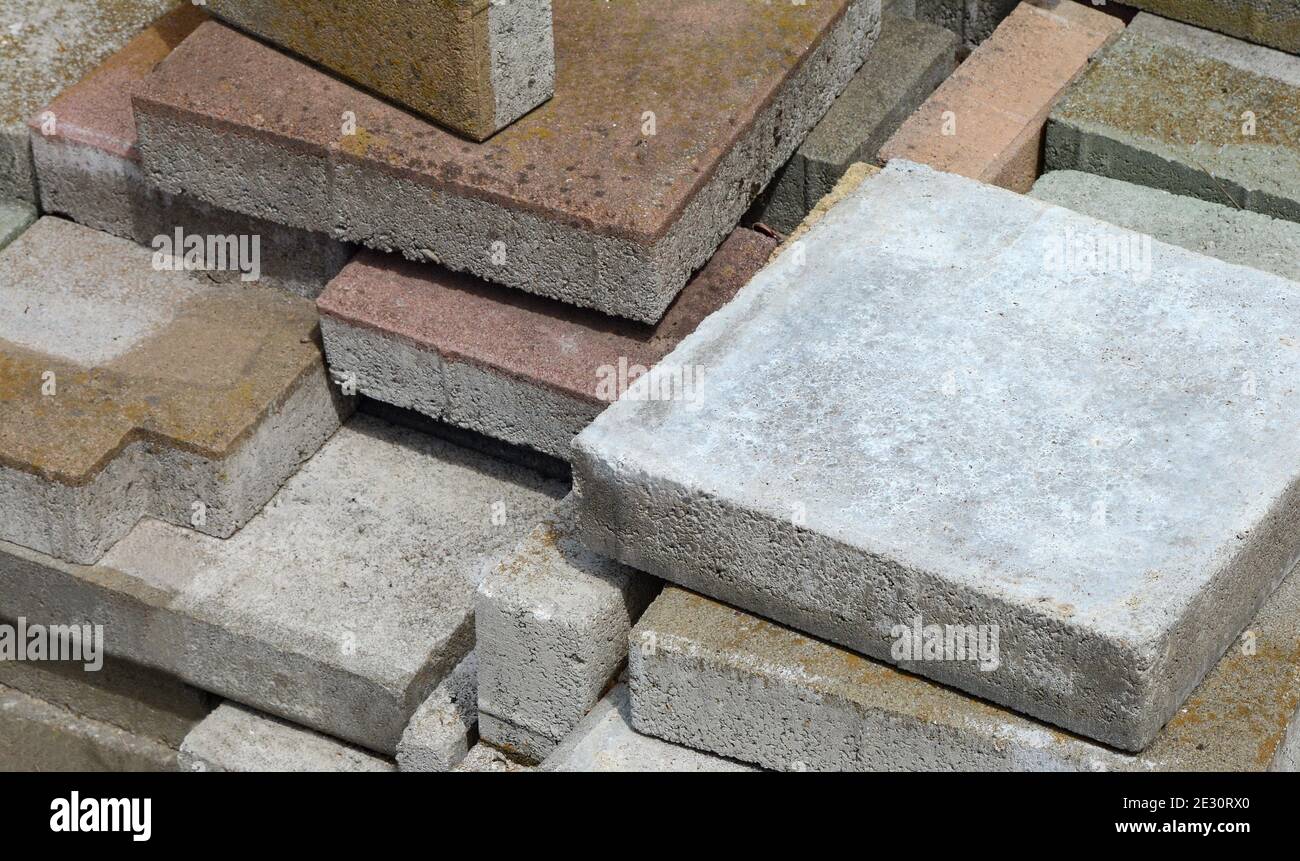 Stack of gray paving slabs. Laying the sidewalk of the tiles ...