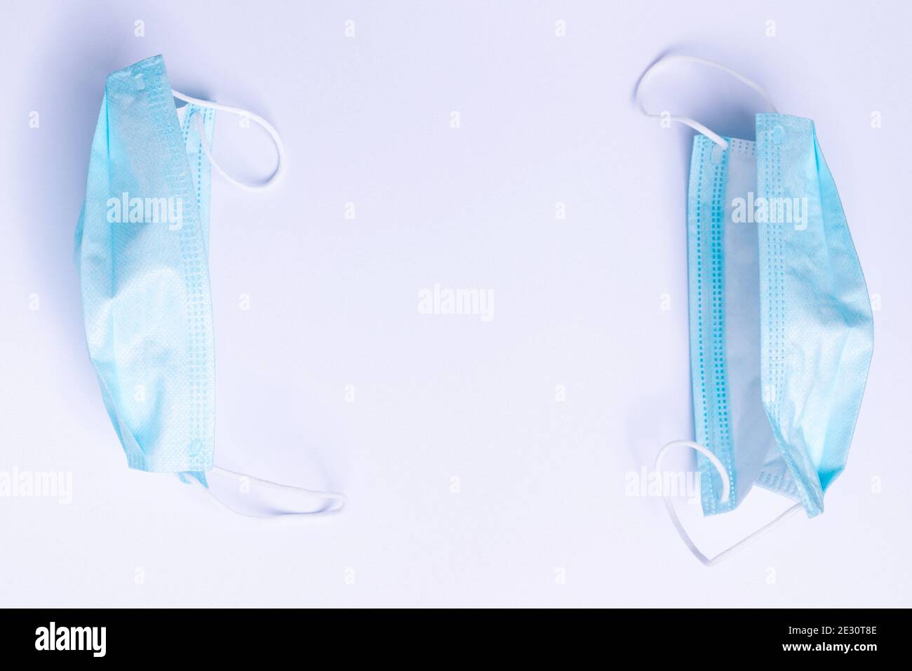 Two disposable medical masks on a white background with a blank space ...