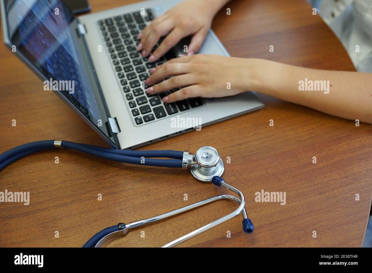Doctor typing treatment on laptop hi-res stock photography and images ...
