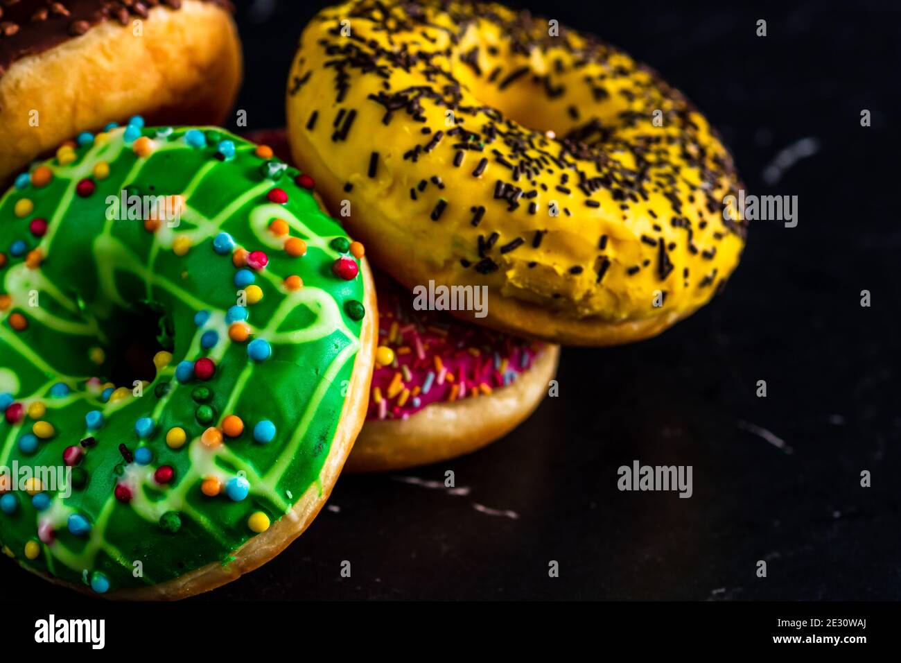 Glazed donuts with sprinkles isolated. Close up of colorful donuts ...