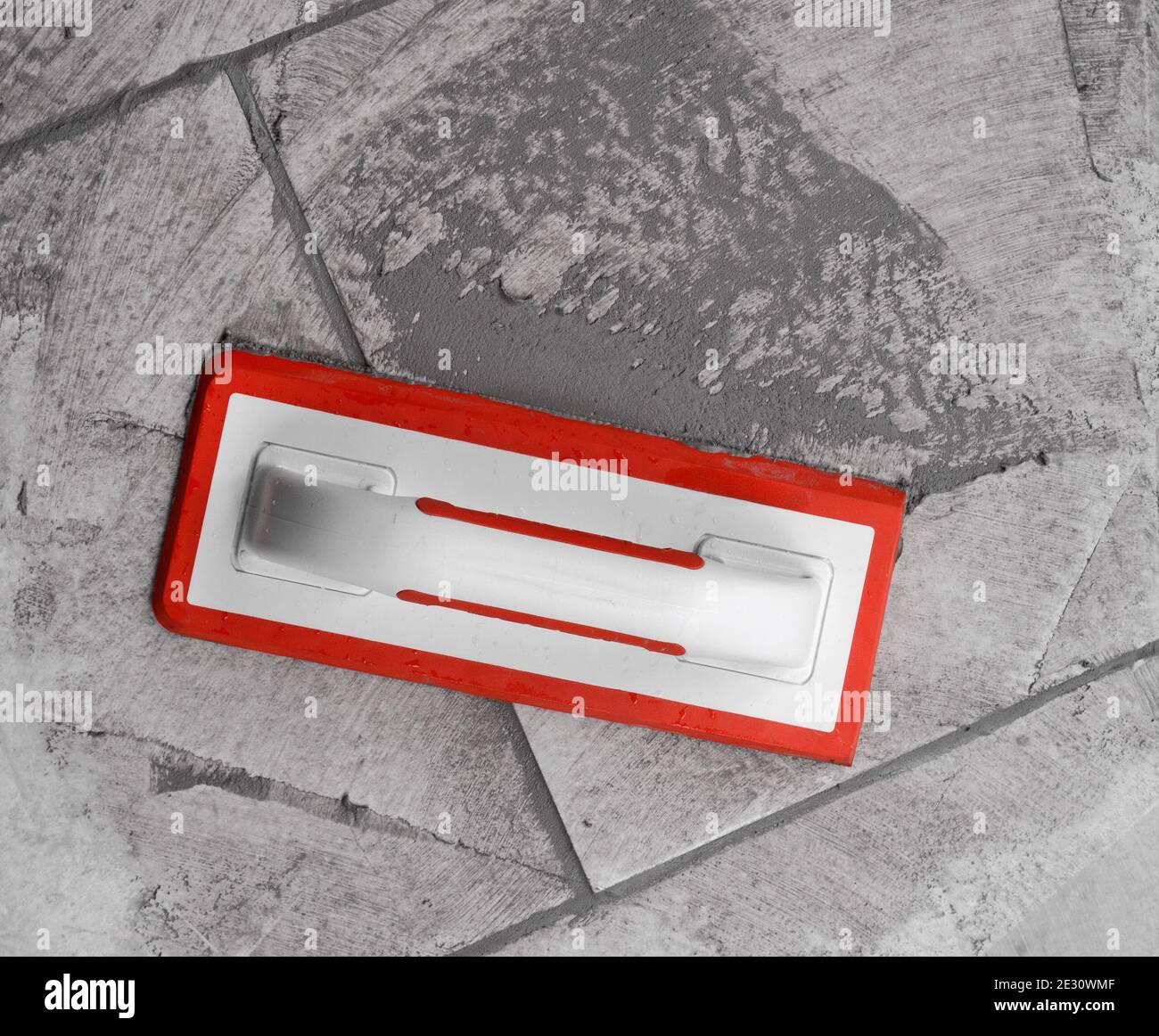 Grouting ceramic tiles. Filling the space between tiles using a rubber ...