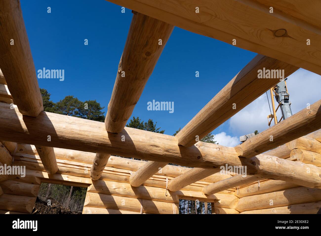 Assembly of a Wooden Log House at a Construction Base Stock Photo - Alamy