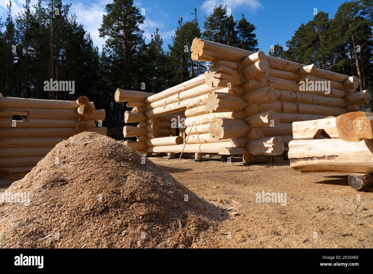 Assembly of a Wooden Log House at a Construction Base Stock Photo - Alamy