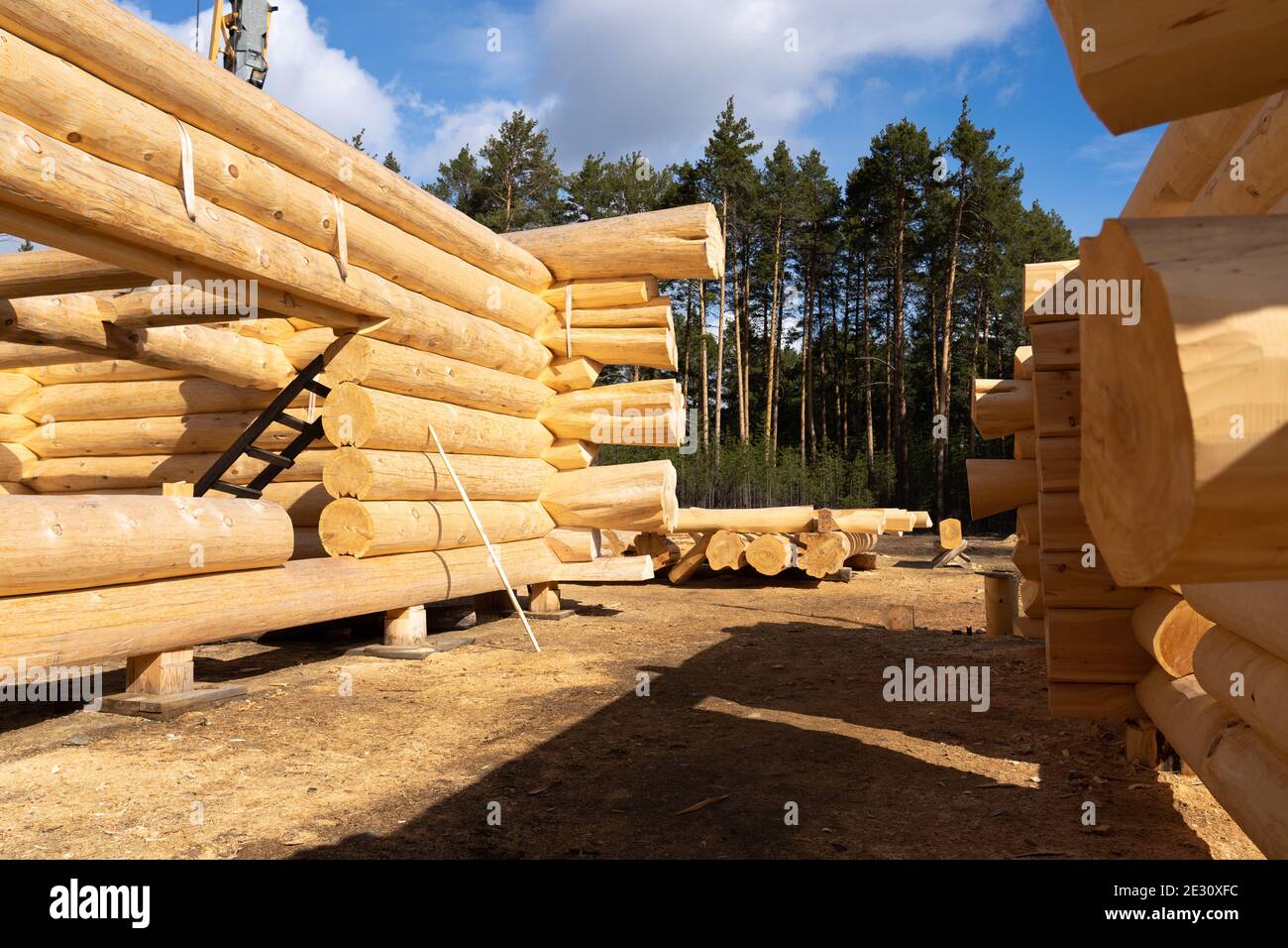 Assembly of a Wooden Log House at a Construction Base Stock Photo - Alamy