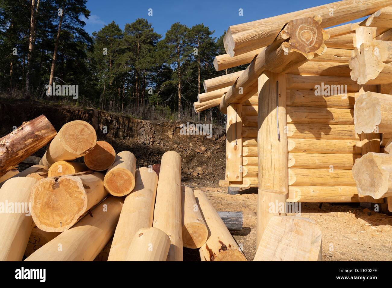 Assembly of a Wooden Log House at a Construction Base Stock Photo - Alamy