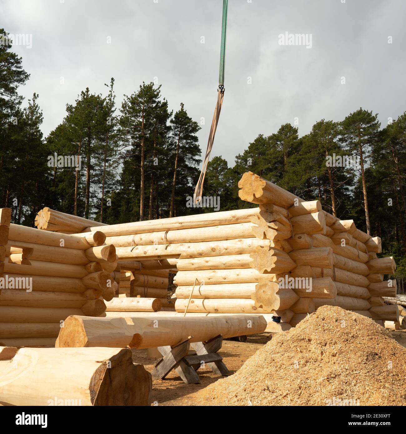 Assembly of a Wooden Log House at a Construction Base Stock Photo - Alamy