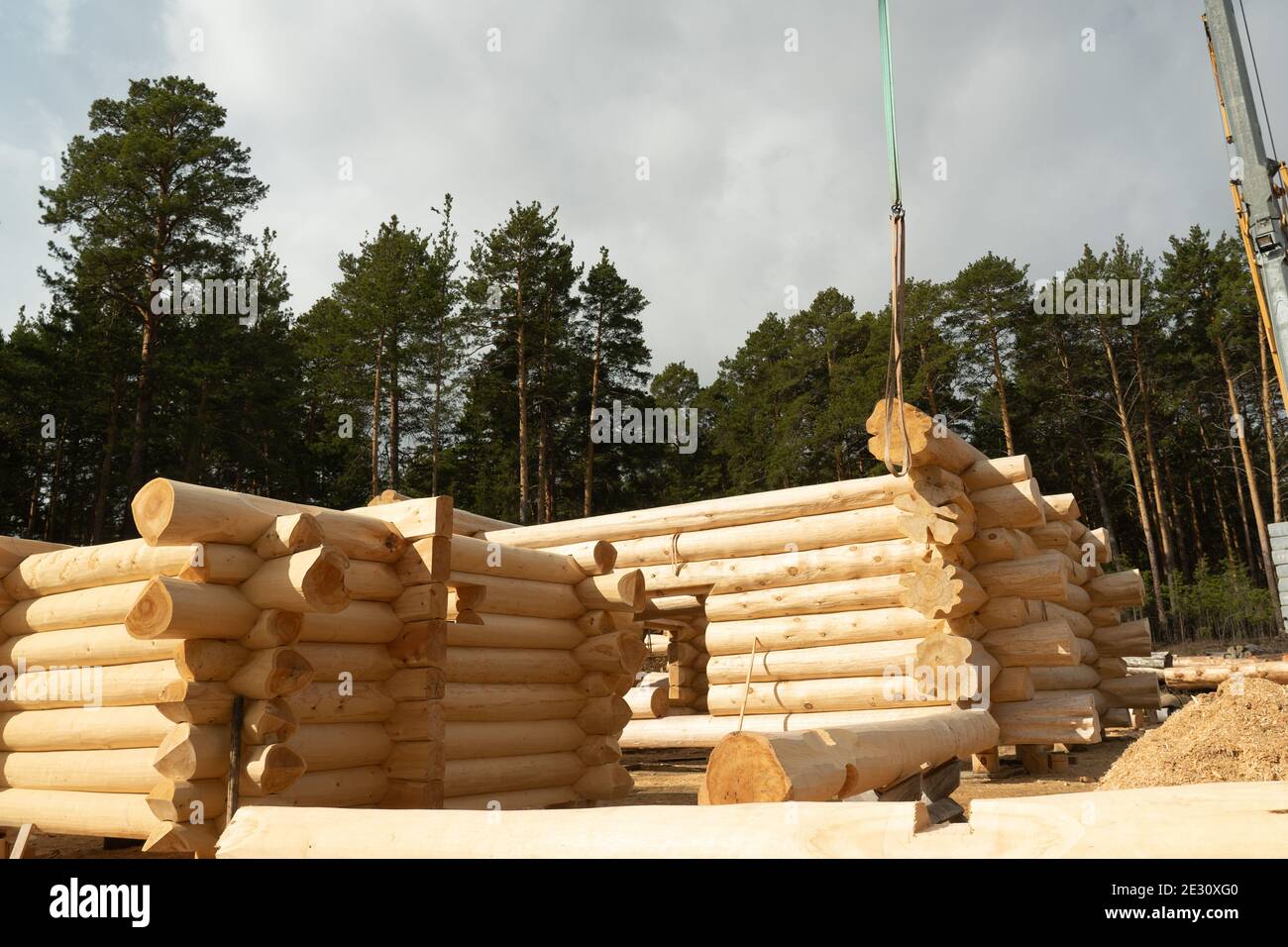 Assembly of a Wooden Log House at a Construction Base Stock Photo - Alamy