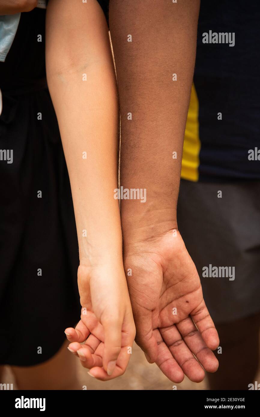 Arms of different color to fight racism. Feminine white and masculine ...