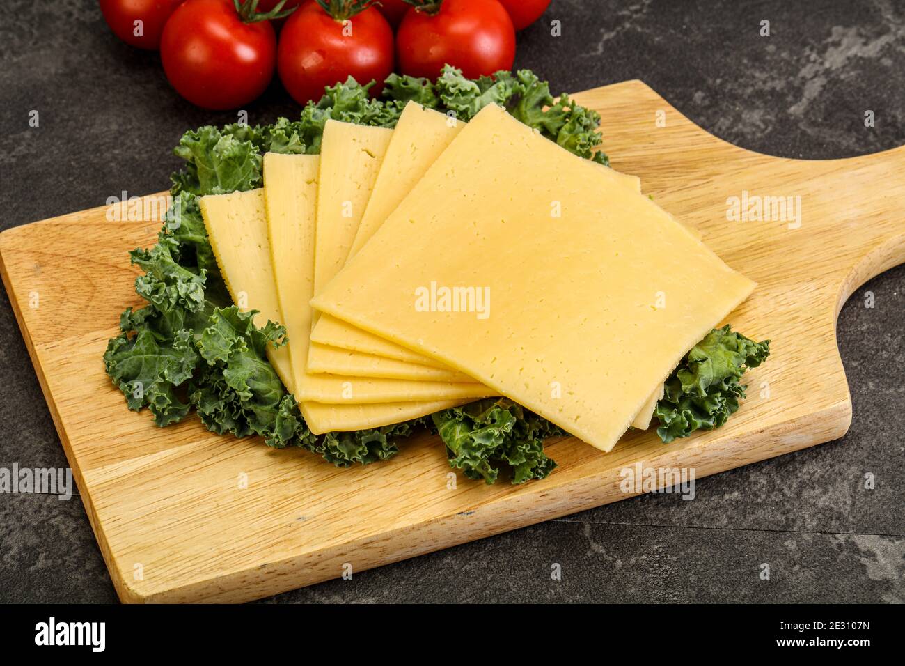 Sliced Gauda cheese snack over board Stock Photo - Alamy