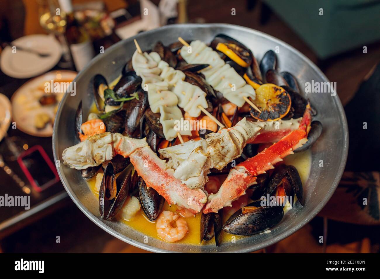 Hand of chef cleaning and preparing fresh raw Giant Mud Crab, serrated ...