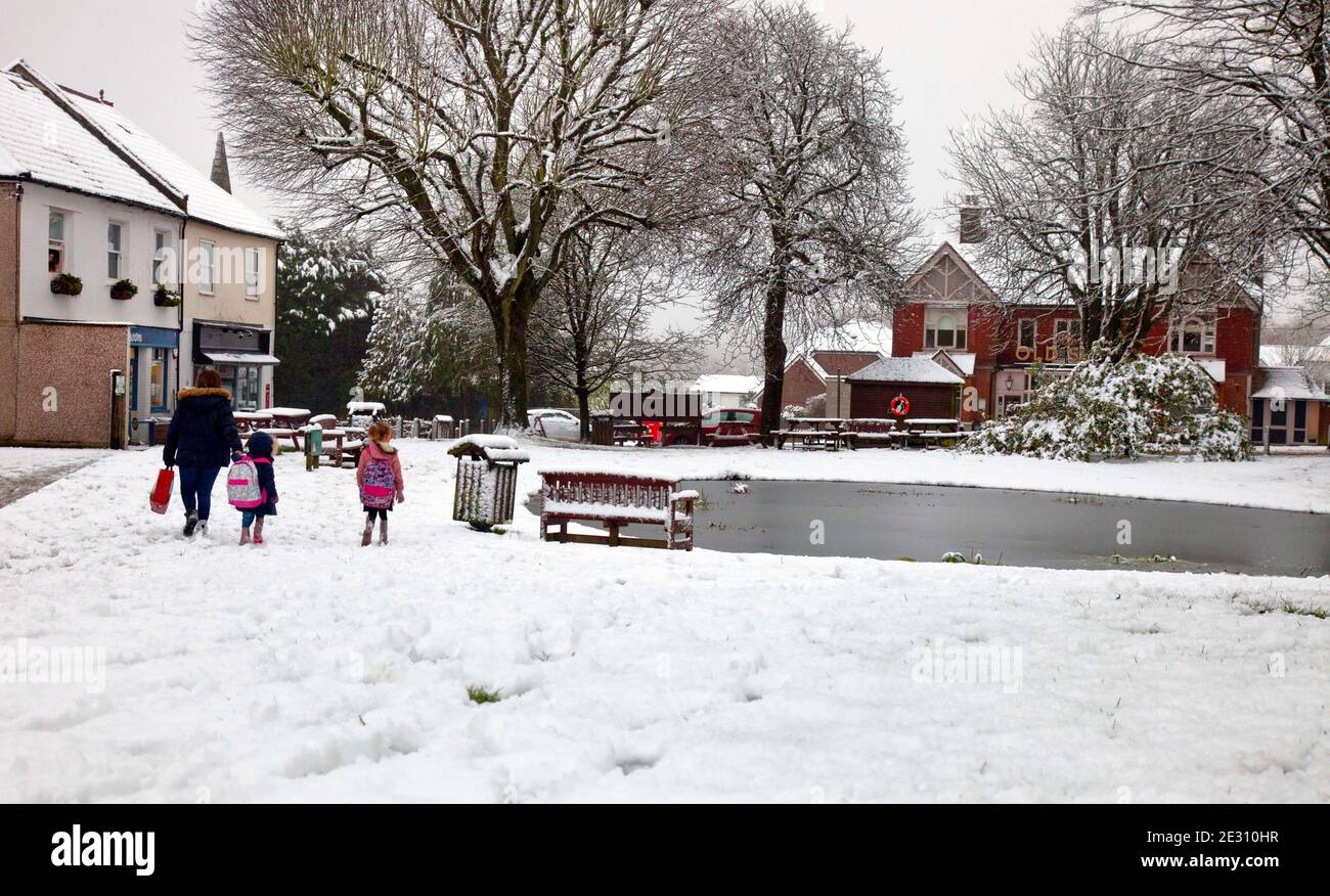 Children walking to school across the snow in Tatsfield village, on the ...