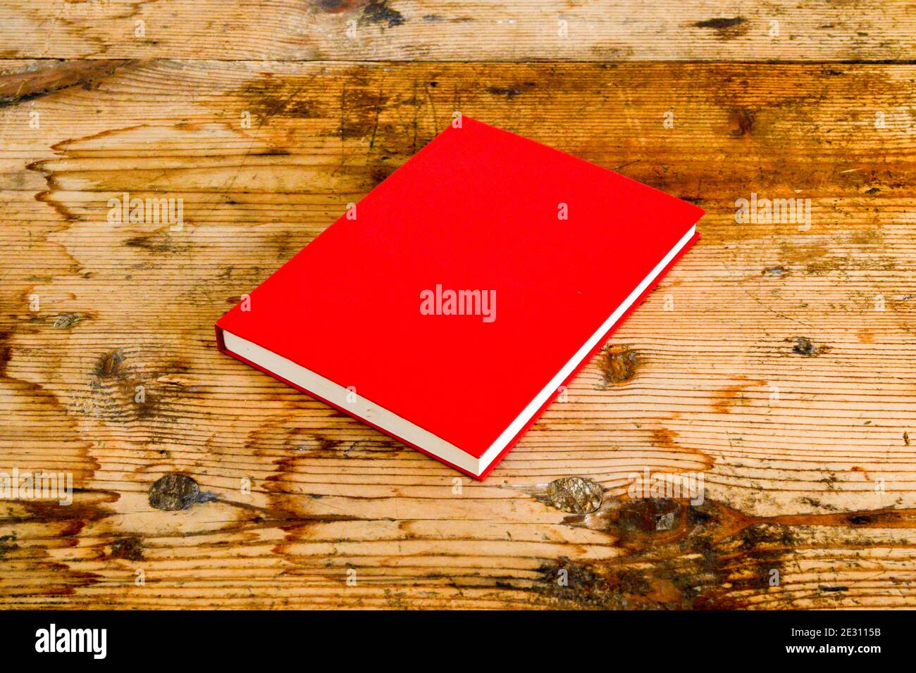 red cover book on old wood background Stock Photo - Alamy