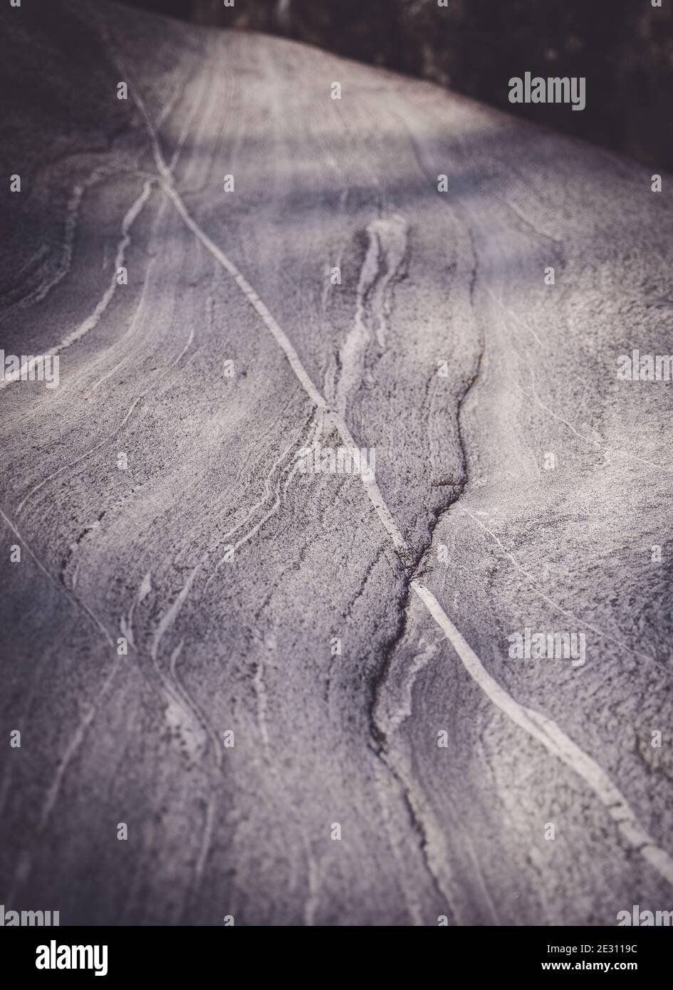 Grey seams of granite rock polished by flowing water Stock Photo - Alamy