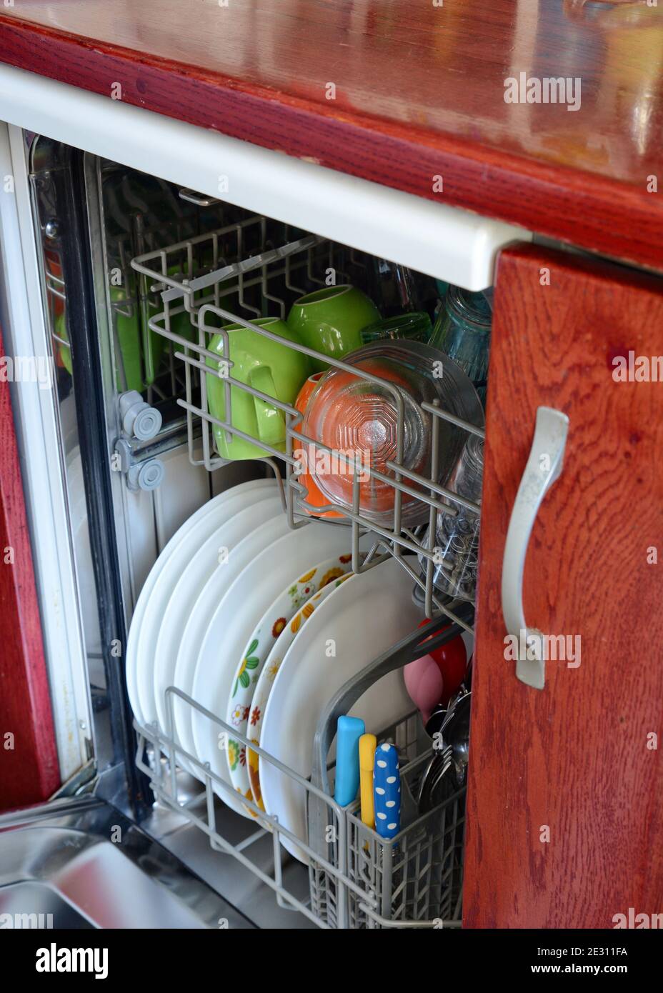Open dishwasher with clean dishes, close up. Dishwasher after cleaning ...