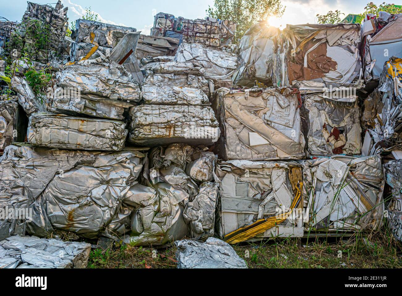Compressed aluminium scrap in large cubes forming landfill in piles ...