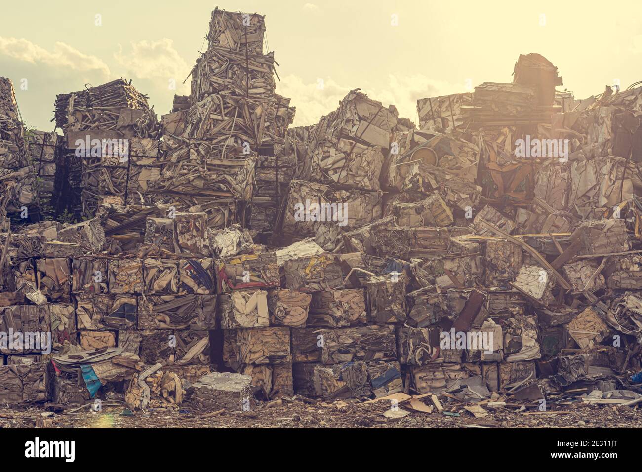 Compressed aluminium scrap in large cubes forming landfill in piles ...