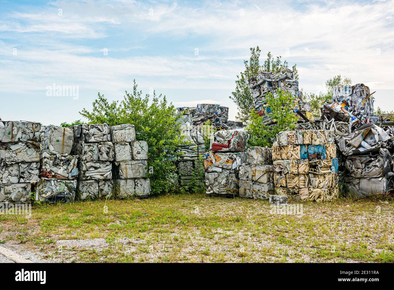 Compressed aluminium scrap in large cubes forming landfill in piles ...