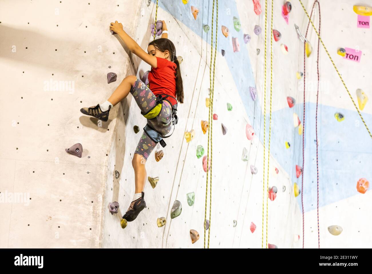 Little Girl Climbing Rock Wall Stock Photo - Alamy