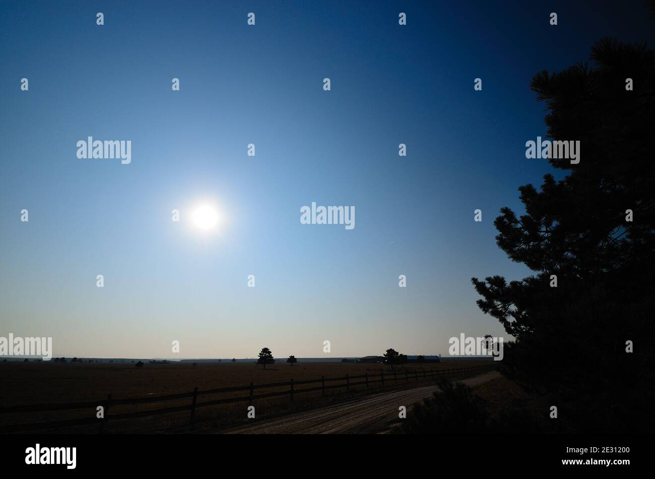 beautiful flat landscape with fence and sun Stock Photo - Alamy