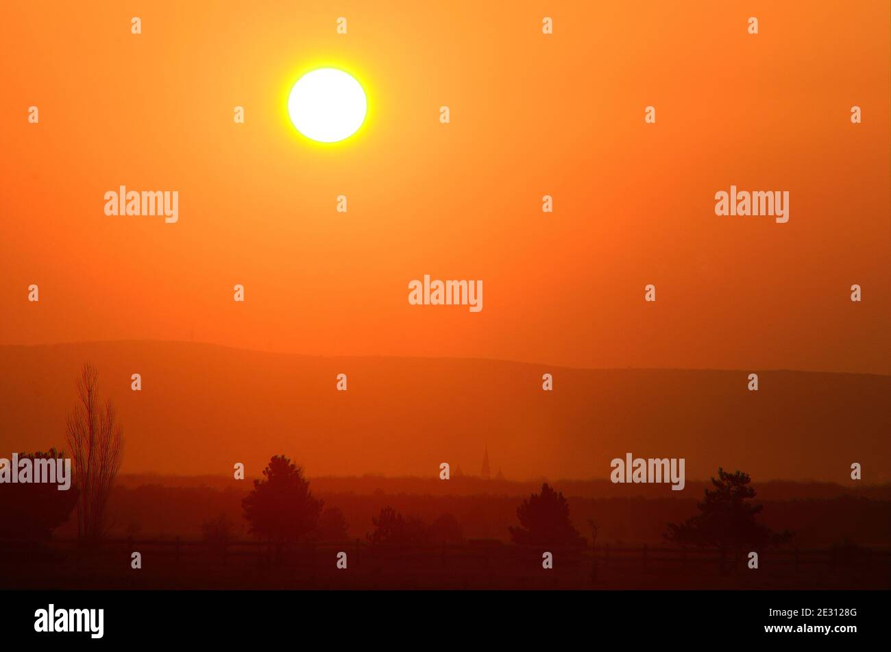beautiful warm sunrise with mountain and village landscape Stock Photo ...