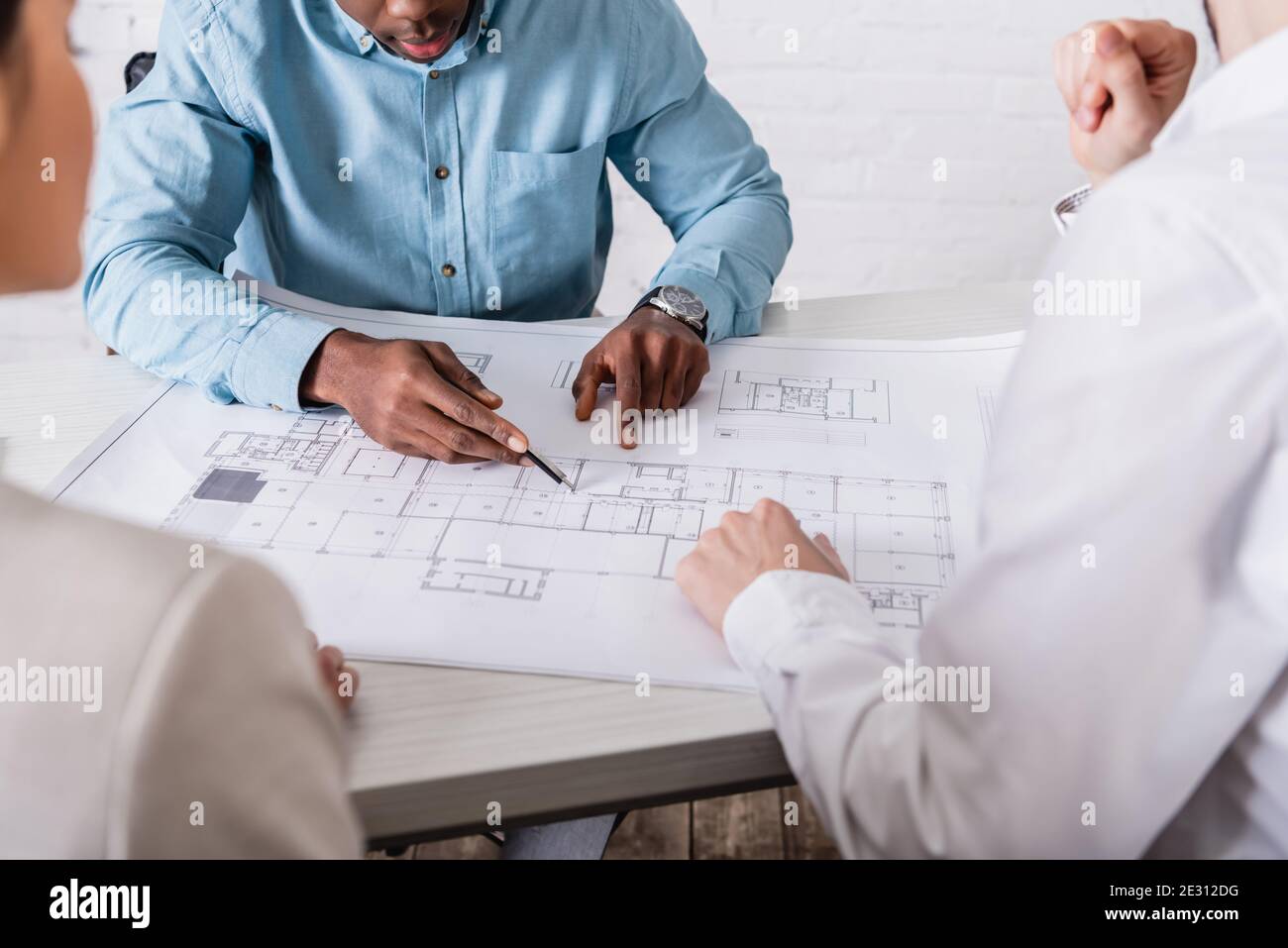 partial view of african american businessman pointing with pencil at ...