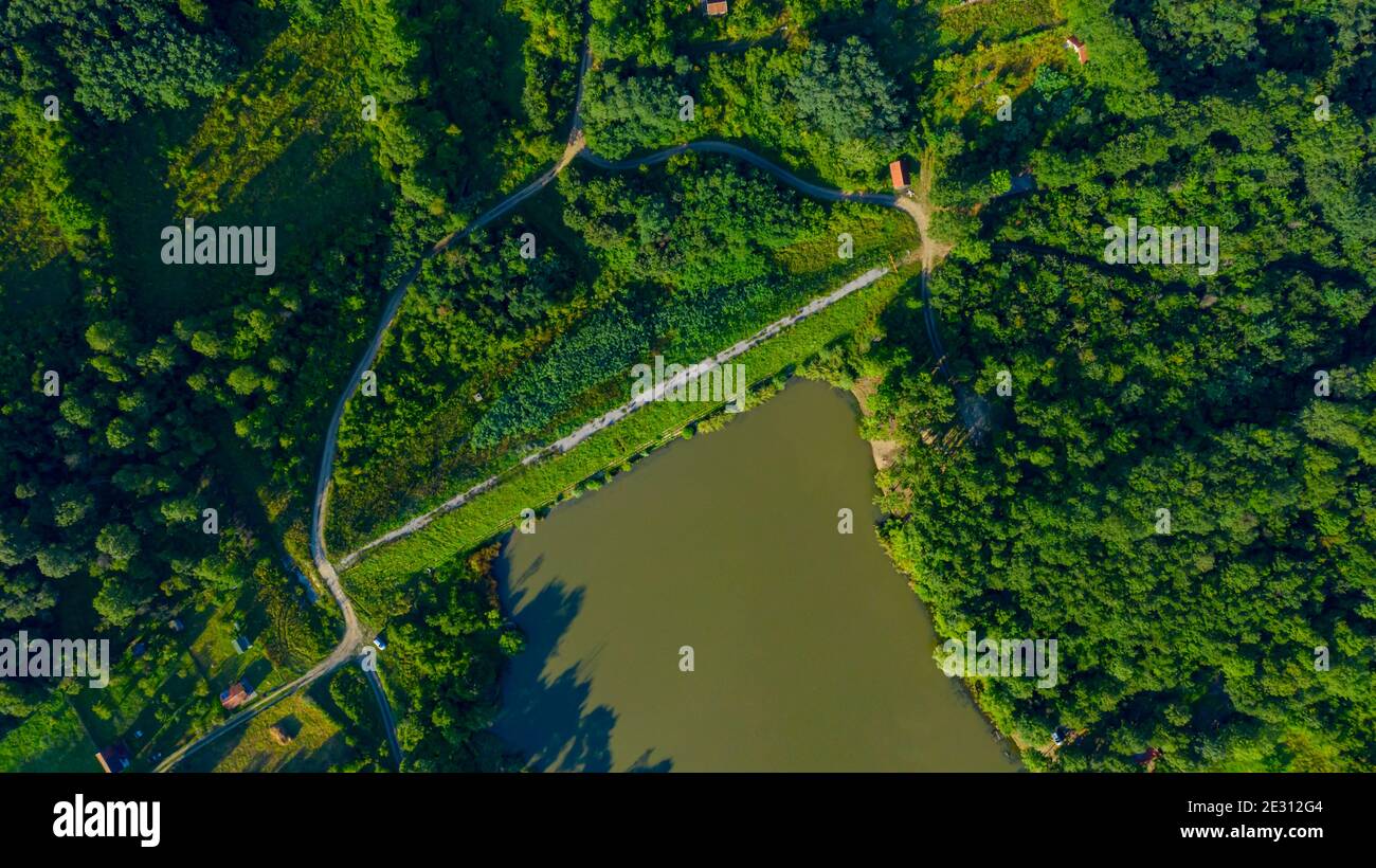 Above view over embankment, dam of lake at hilly landscape, woodland ...