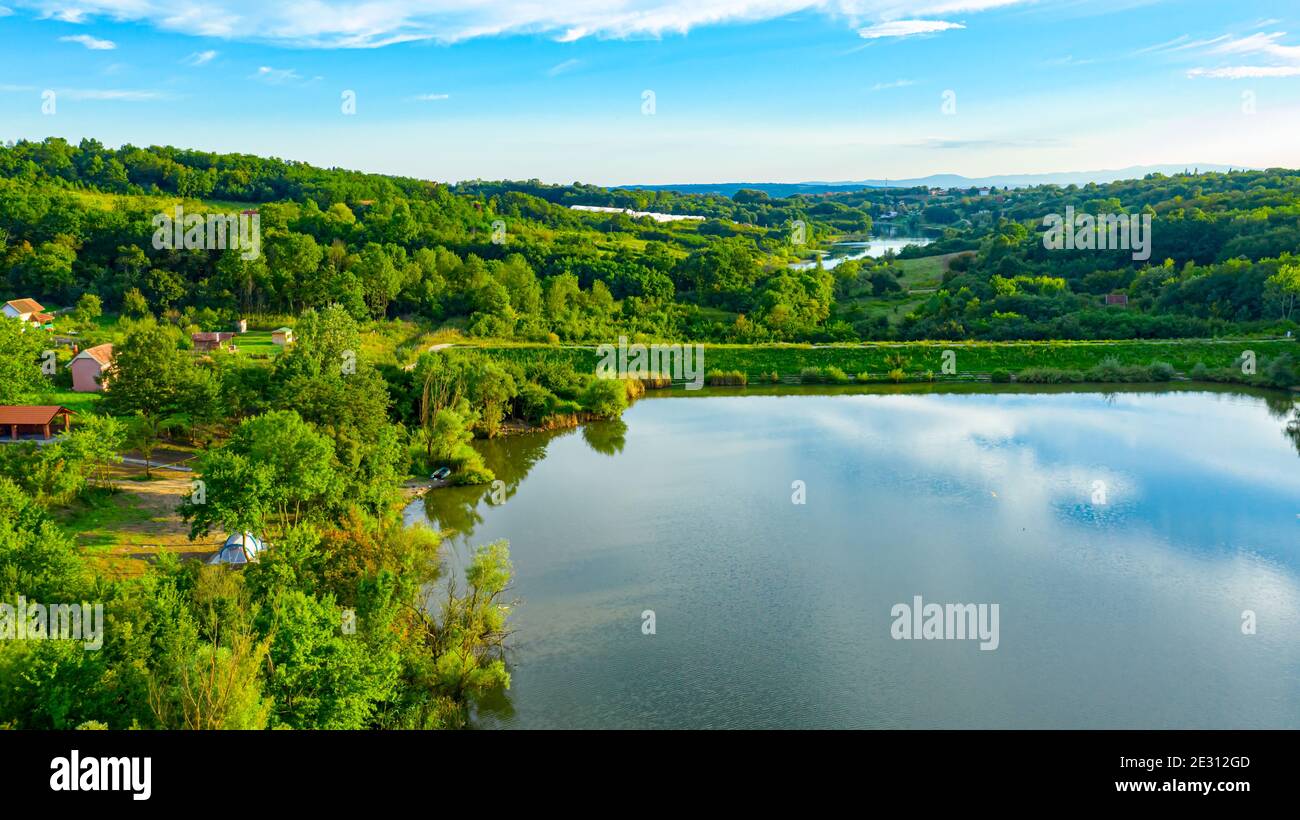 Above view over embankment, dam of lake at hilly landscape, woodland ...