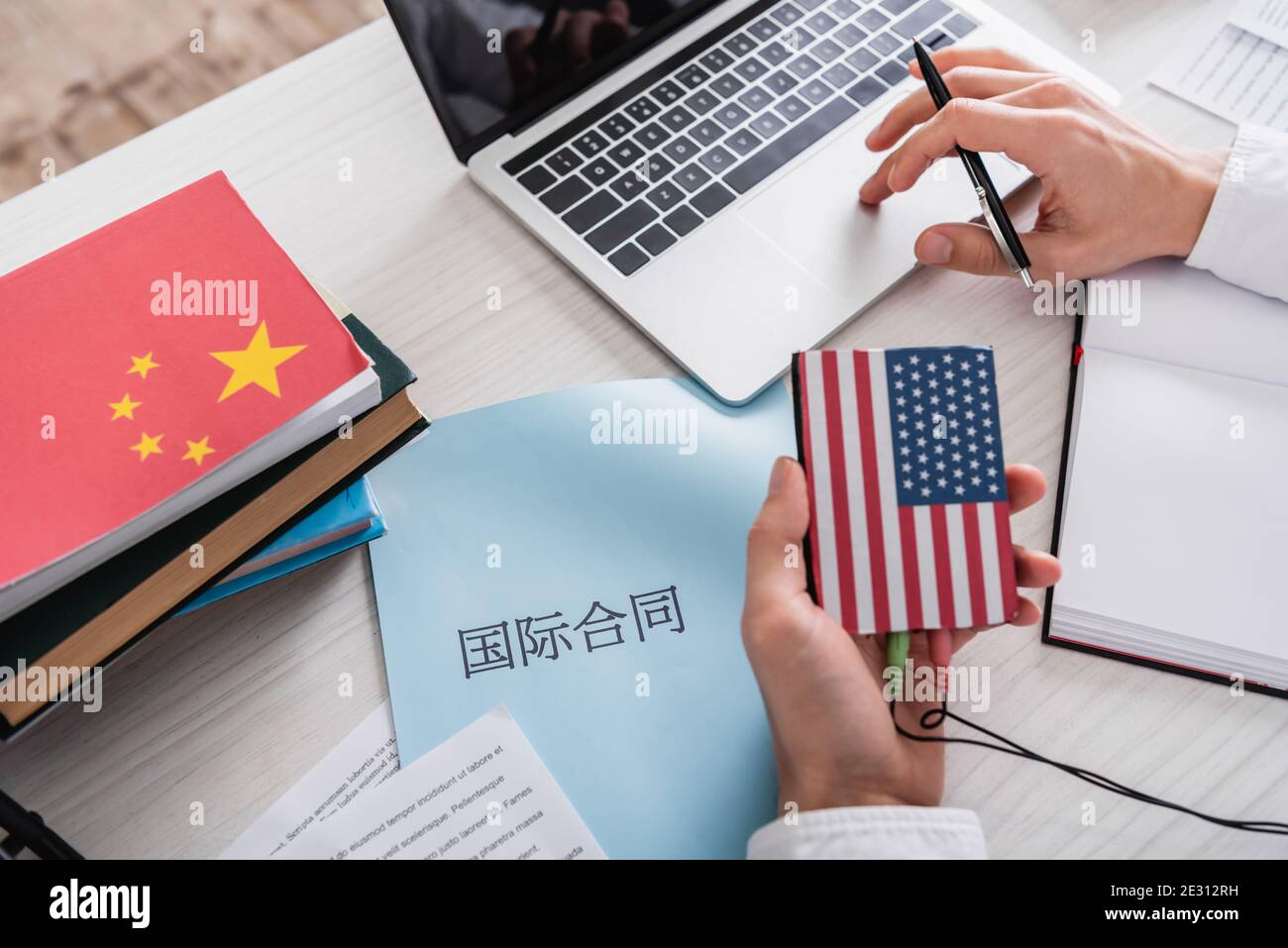 partial view of interpreter holding digital translator with usa flag ...