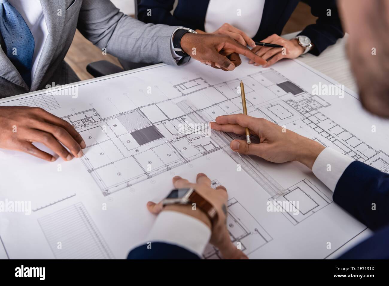 partial view of african american businessman pointing with finger at ...