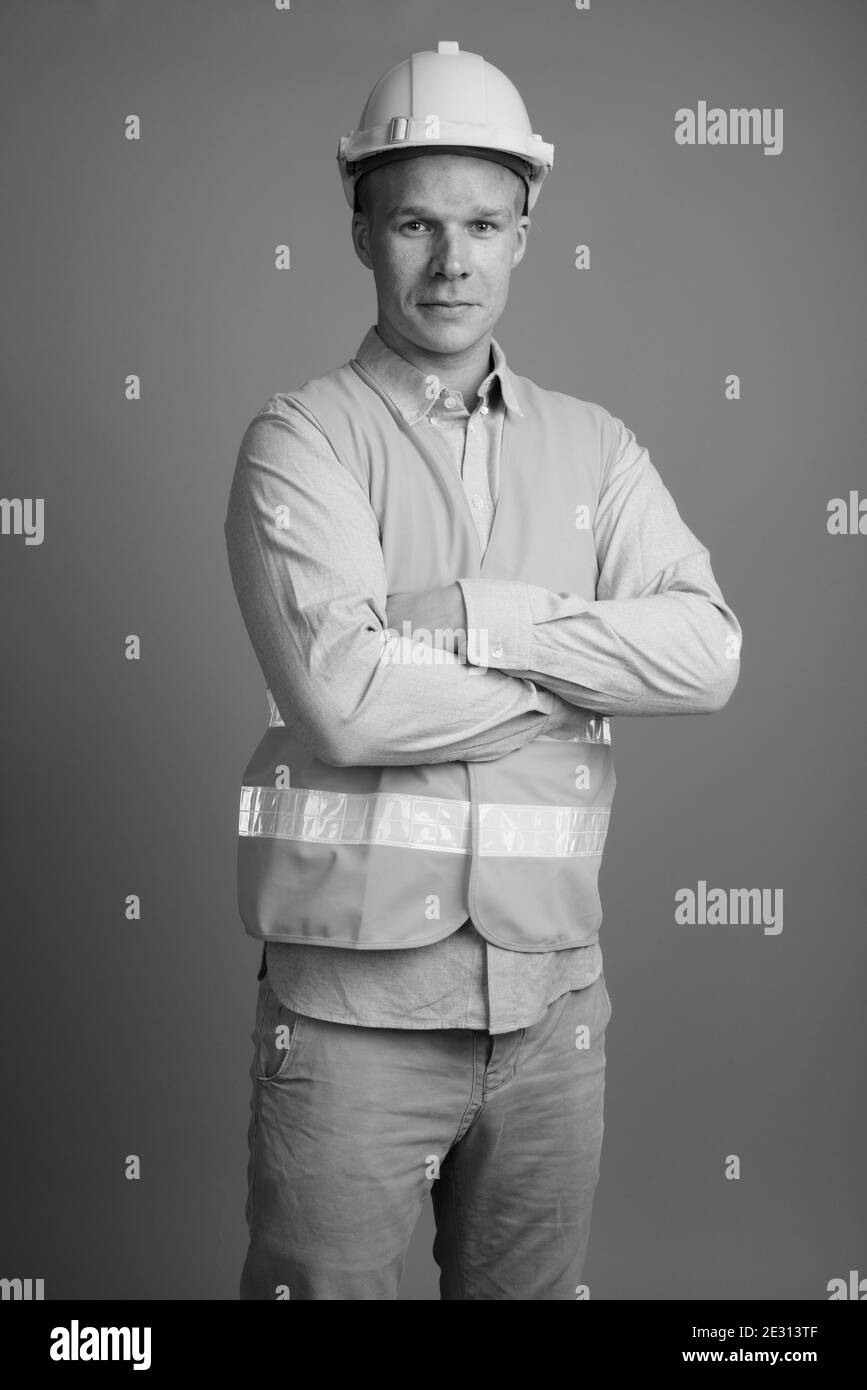 Man construction worker against gray background Stock Photo - Alamy