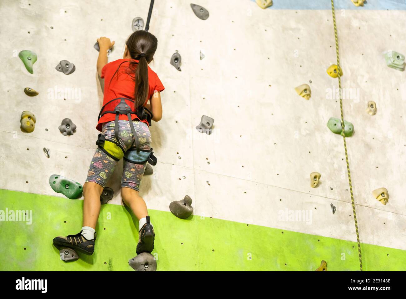 Little Girl Climbing Rock Wall Stock Photo - Alamy