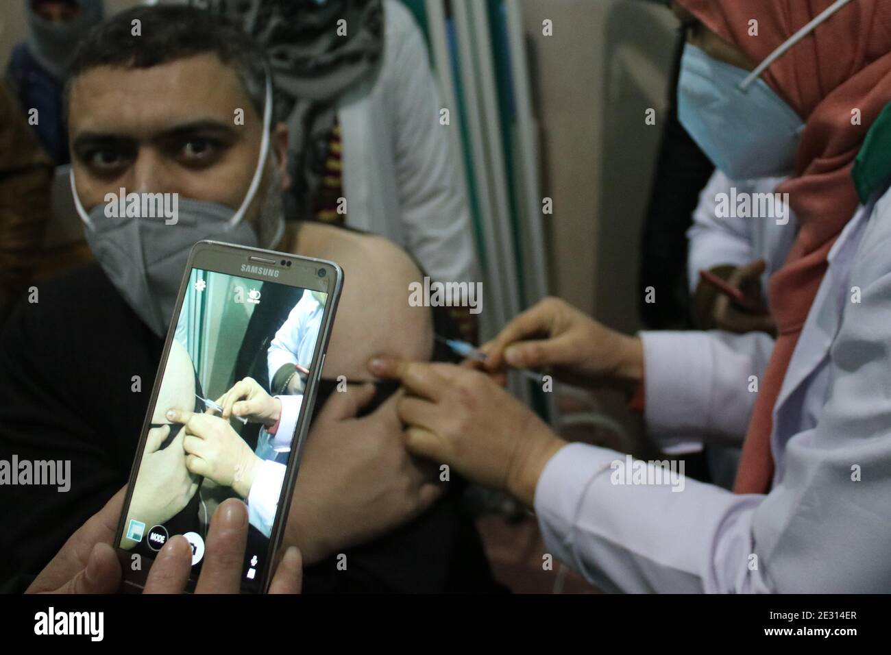 Srinagar, India. 16th Jan, 2021. A Kashmiri Doctor receive a Covid19 ...