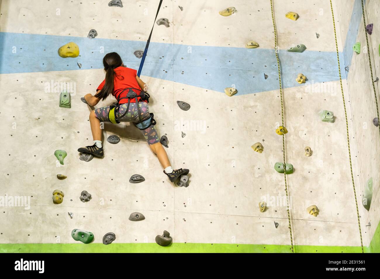 Little Girl Climbing Rock Wall Stock Photo - Alamy