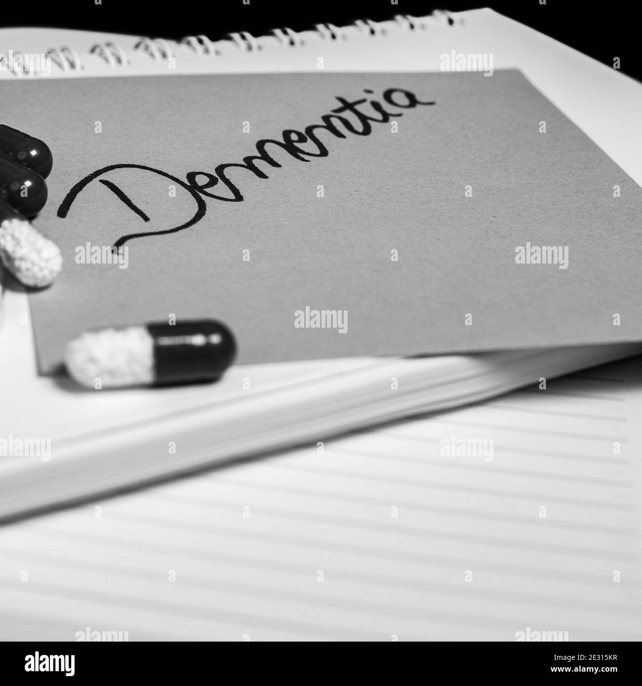 Writing Dementia on memo post reminder and medicines, pills. Writing ...