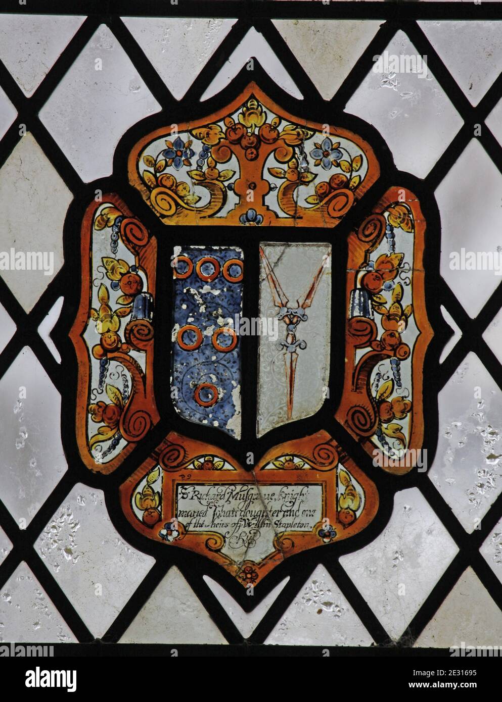 A stained glass window depicting coat of arms; Musgrave impaling ...