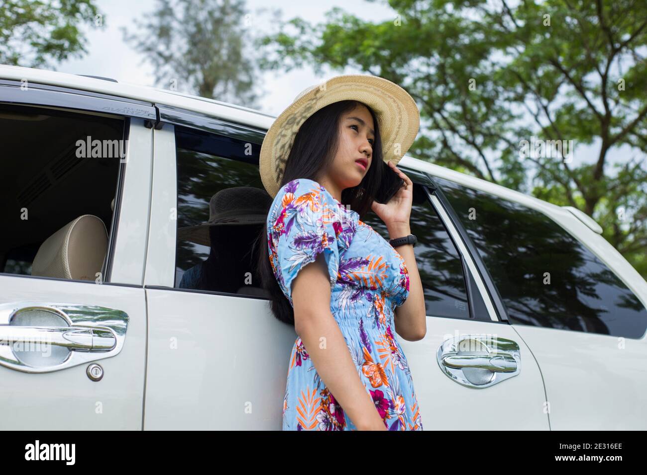 portrait of beautiful asian woman smiling while holding mobile phone ...