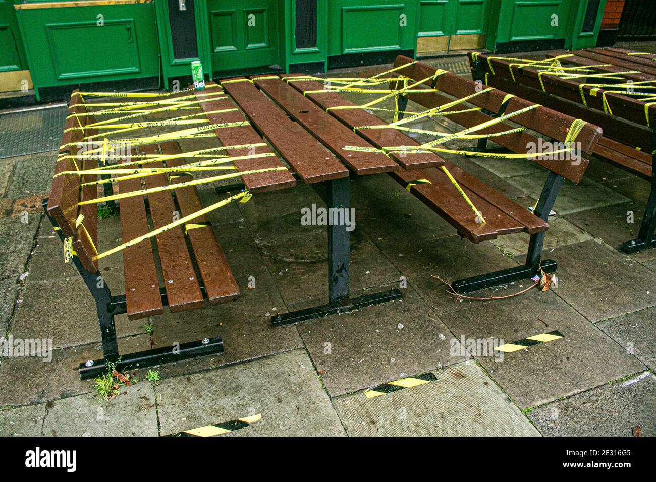 PUTNEY LONDON, UK 16 January 2021. Pub benches are taped off outside ...