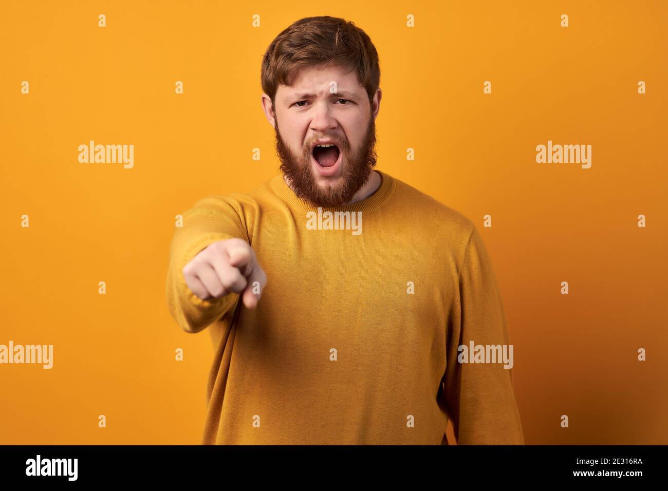 Furious angry unshaven man looses temper, going crazy, screams with ...