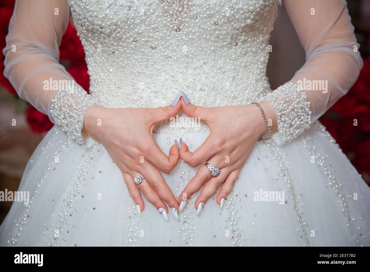 The bride made a heart shape from her fingers. He has a white gold ...