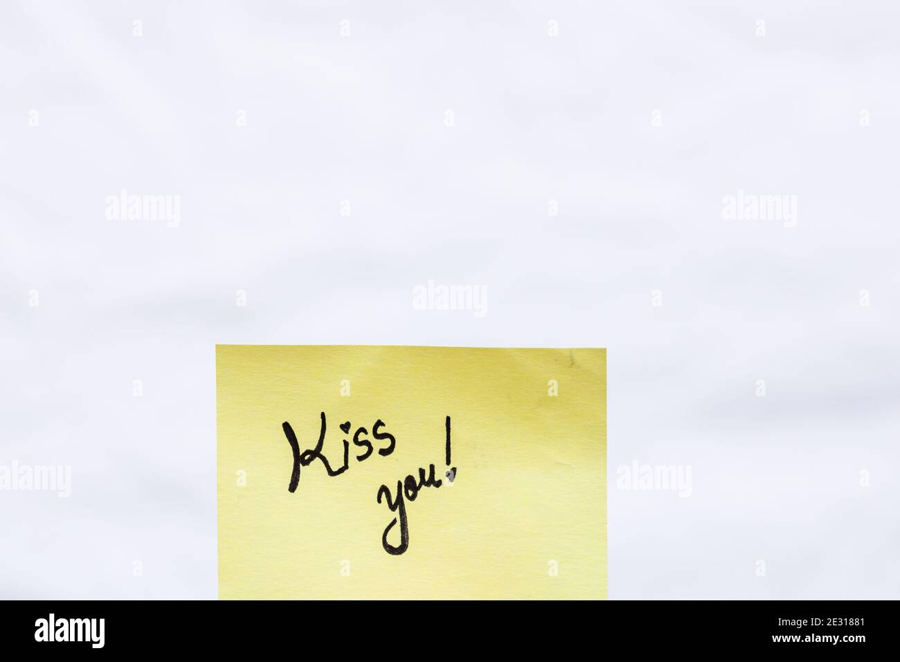 Kiss you handwriting text close up isolated on yellow paper with copy ...