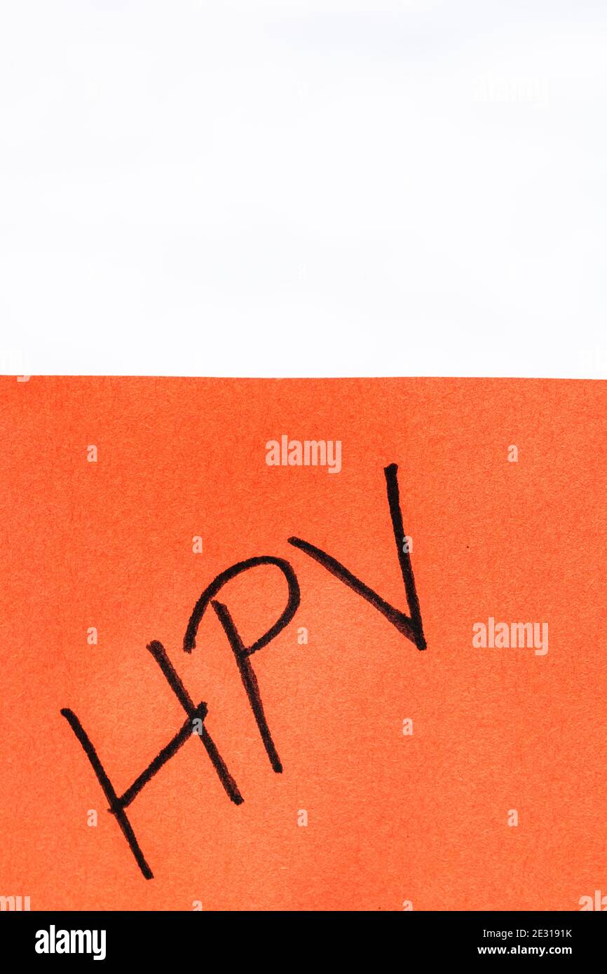 HPV handwriting text close up isolated on orange paper with copy space ...