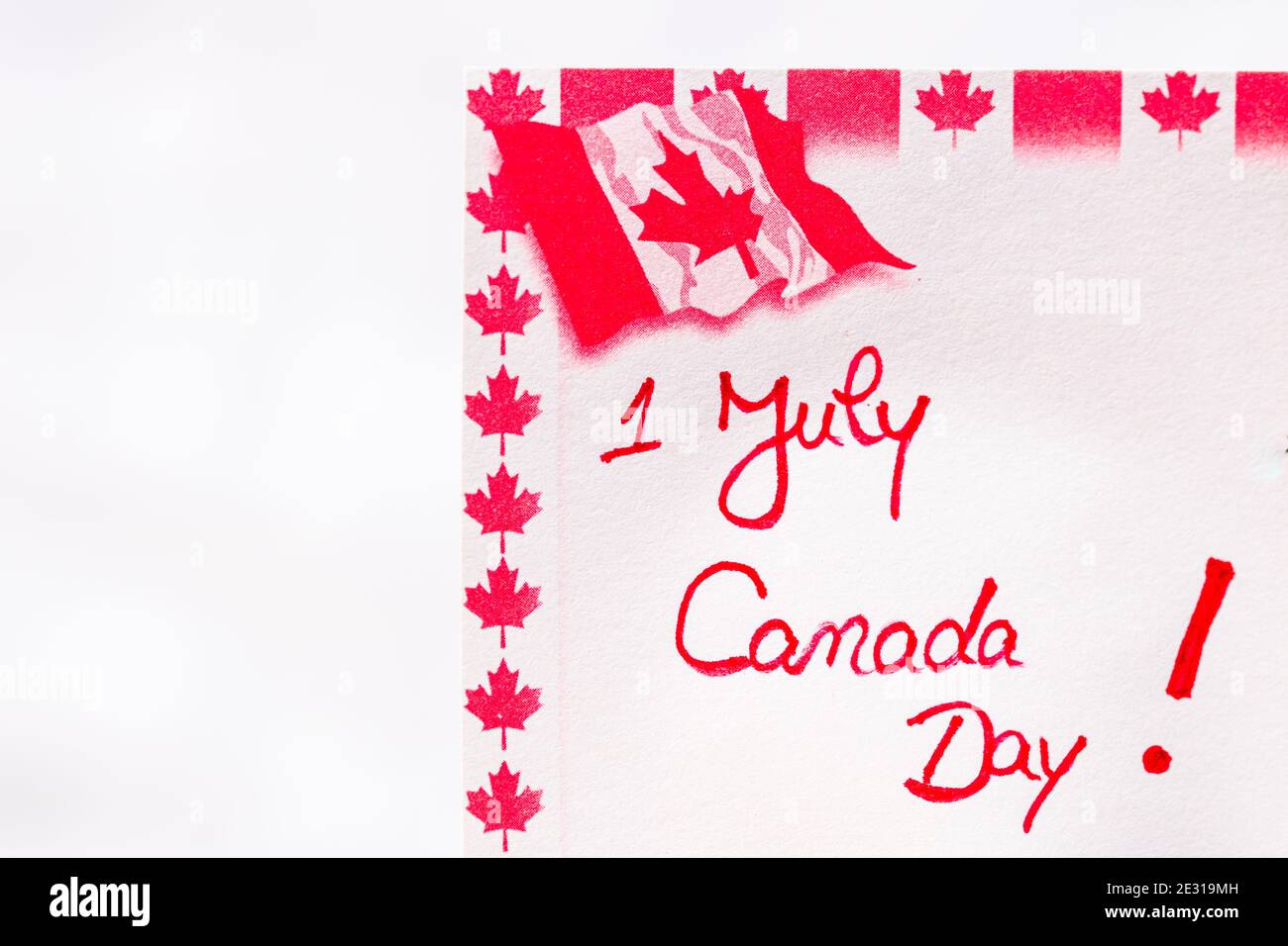 Canada day 1 July handwriting on paper with Canada flag. Writing text ...