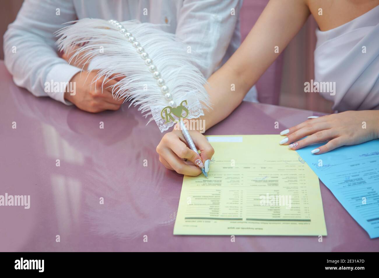A woman's hand signs and registers his marriage with the woman he loves ...