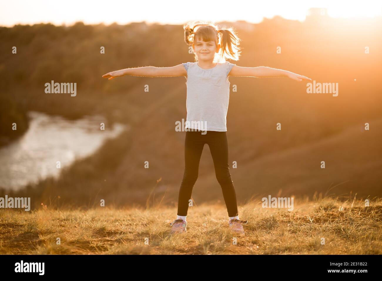 Little girl doing fitness exercises hi-res stock photography and images ...