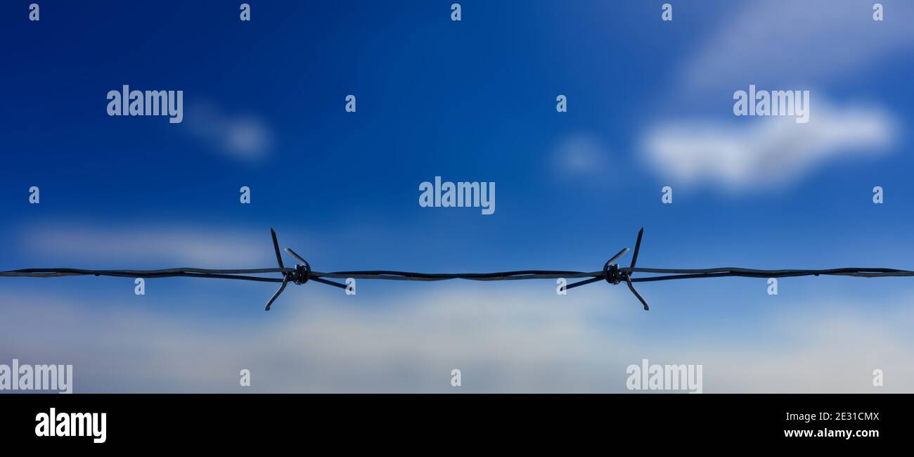 Barbed wire on blue cloudy sky background, Close up view of horizontal ...