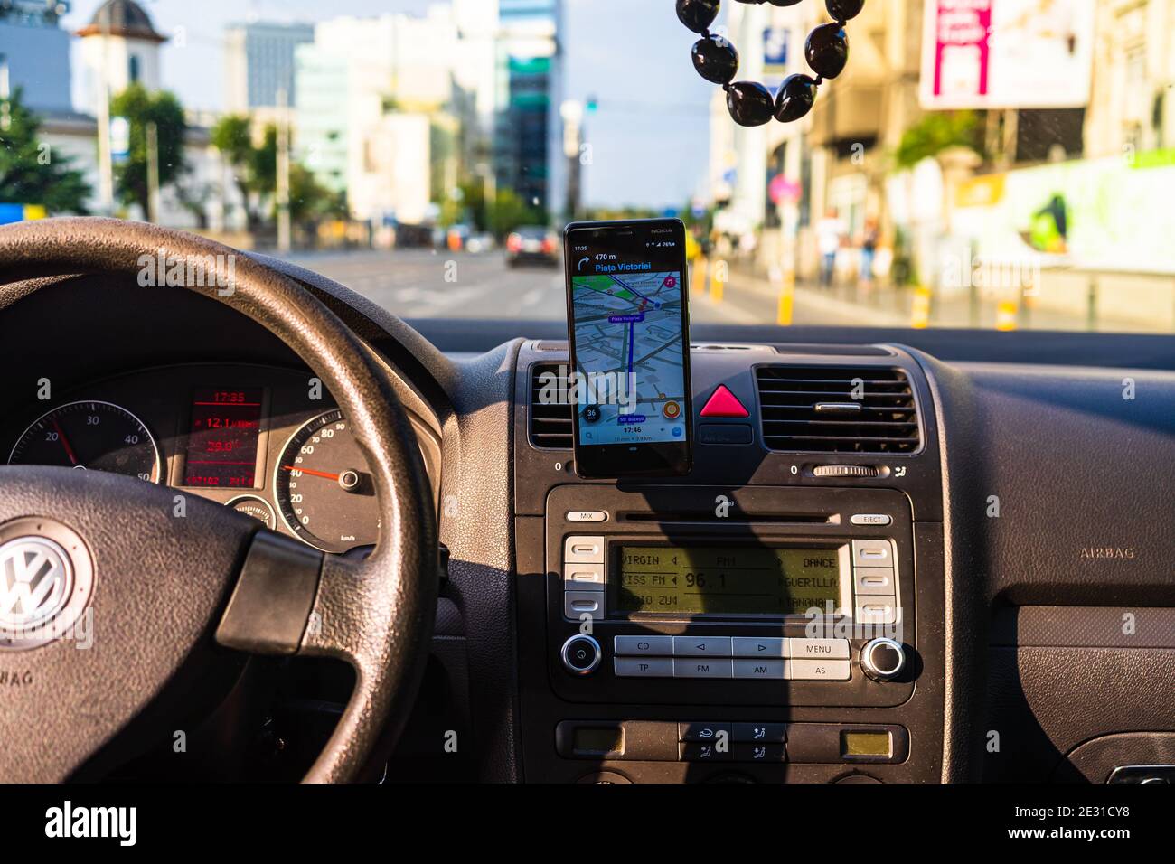 In car dashboard view with smartphone showing Police on Waze maps ...