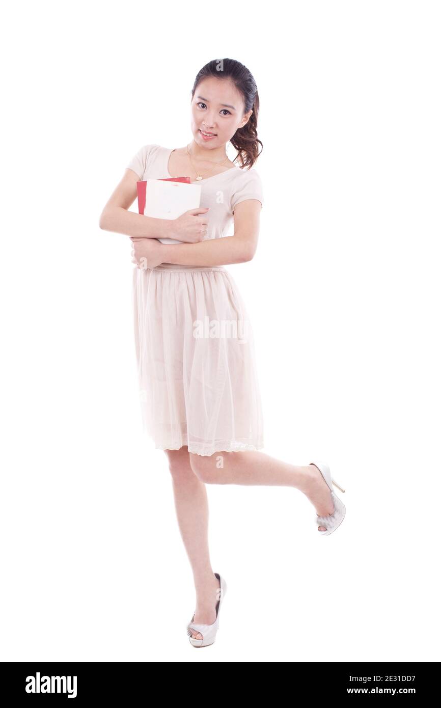 A Young woman standing, hugging a book high quality photo Stock Photo ...